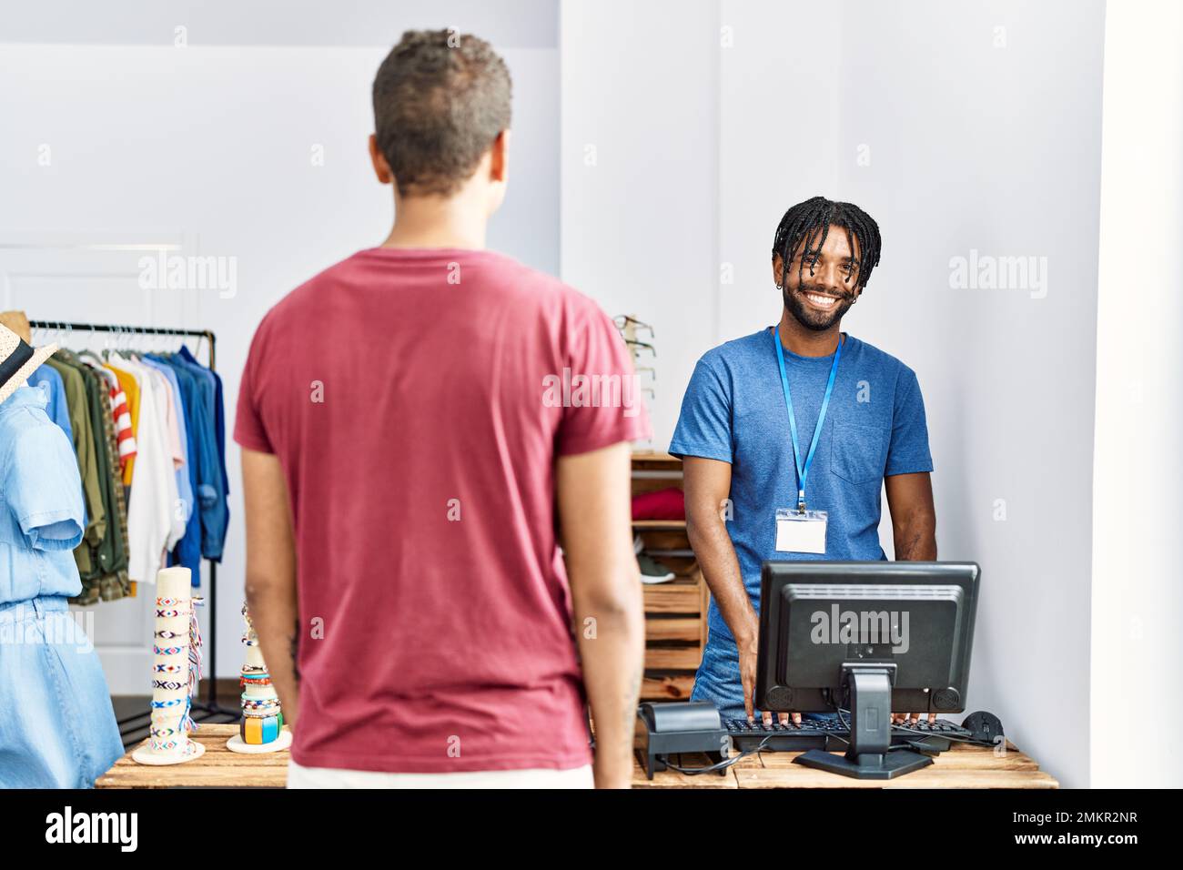 Two men shopkeeper and customer standing at clothing store Stock Photo ...