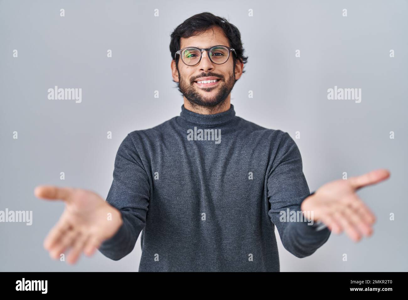 Handsome latin man standing over isolated background smiling cheerful ...
