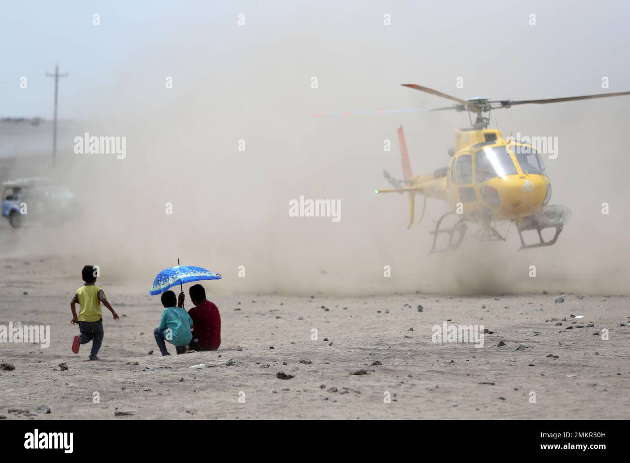 A helicopter lands at the finish line of the third stage of the Dakar ...