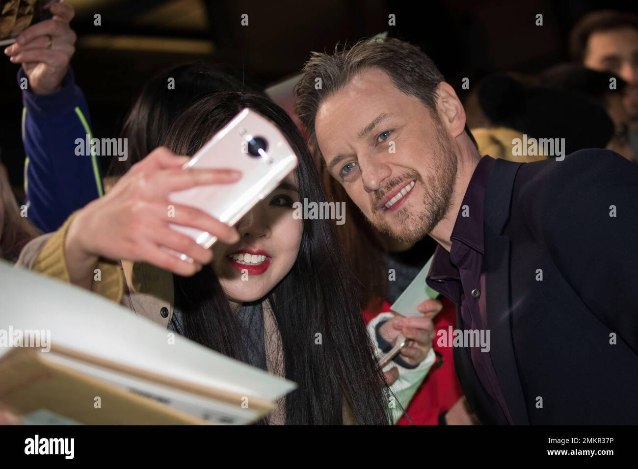 Actor James McAvoy poses for photographs with fans upon arrival at the ...