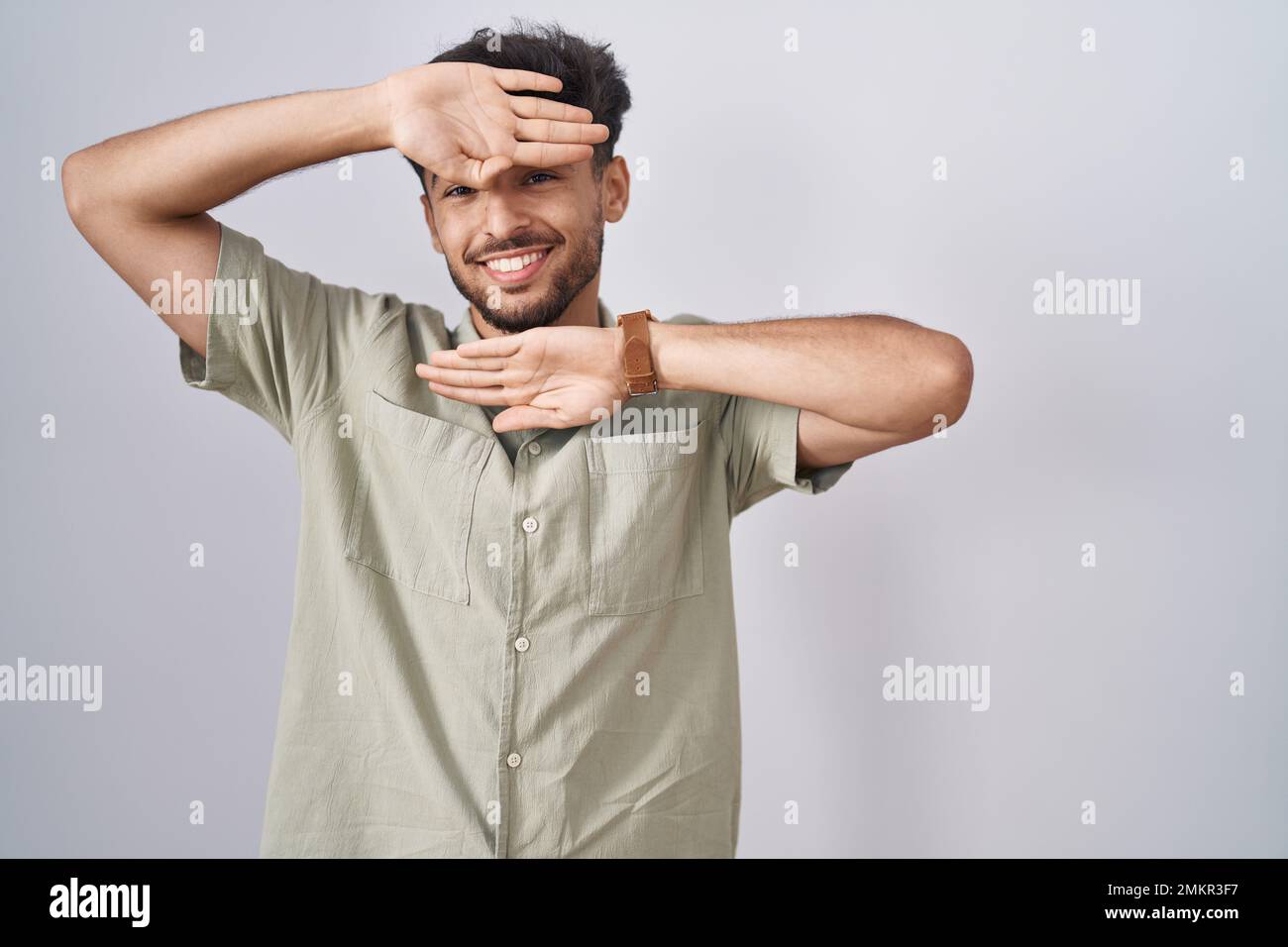 Arab man with beard standing over white background smiling cheerful ...
