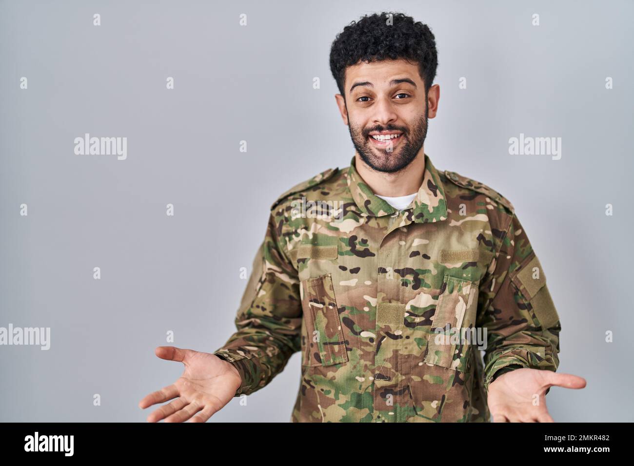 Arab man wearing camouflage army uniform smiling cheerful with open ...
