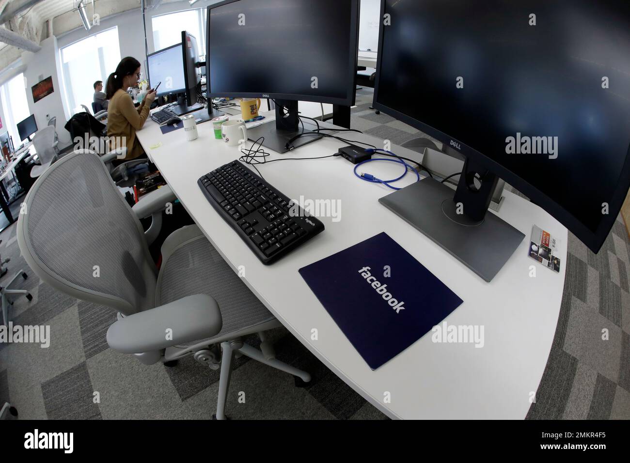 In this Jan. 9, 2019 photo, Facebook employees are seen at their ...