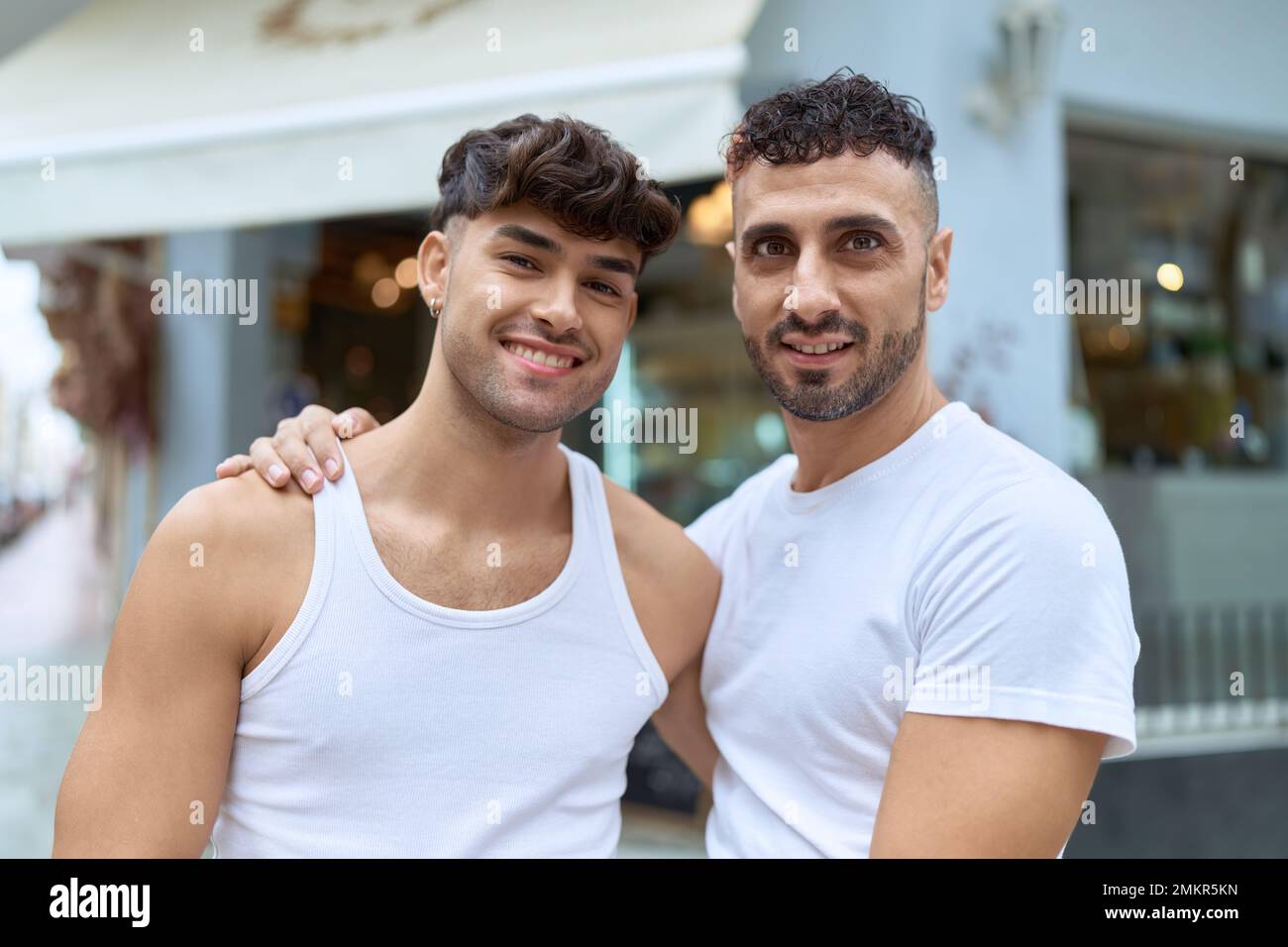 Two hispanic men couple smiling confident hugging each other at coffee shop terrace Stock Photo ...