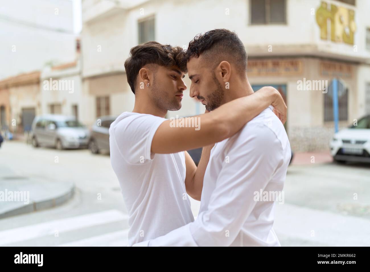 Two hispanic men couple hugging each other with relaxed expression at ...
