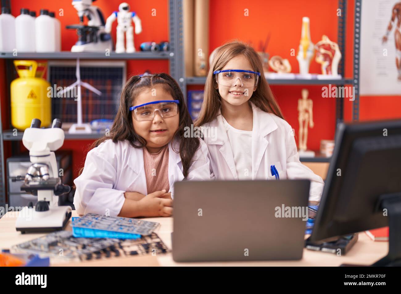Two kids students using laptop at laboratory classroom Stock Photo - Alamy
