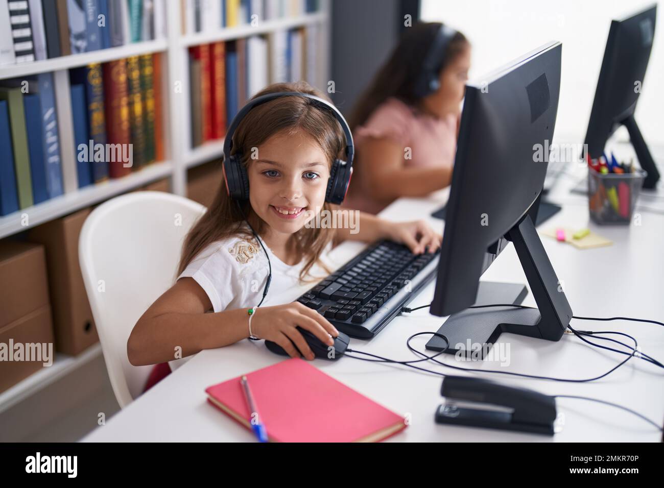 Two kids students using computer studying at classroom Stock Photo - Alamy