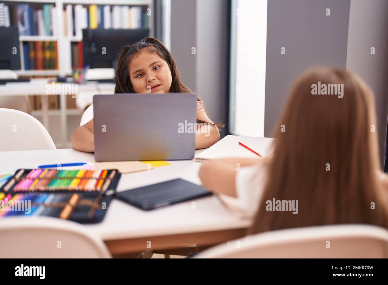 Two kids students using laptop studying at classroom Stock Photo - Alamy