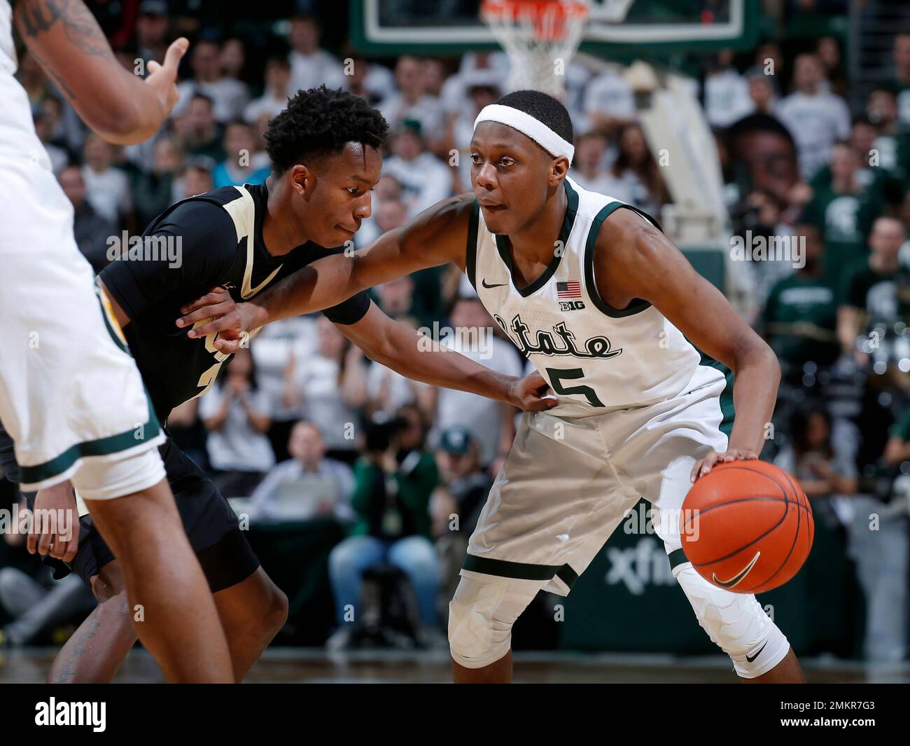 Michigan State's Cassius Winston, right, drives against Purdue's Eric ...