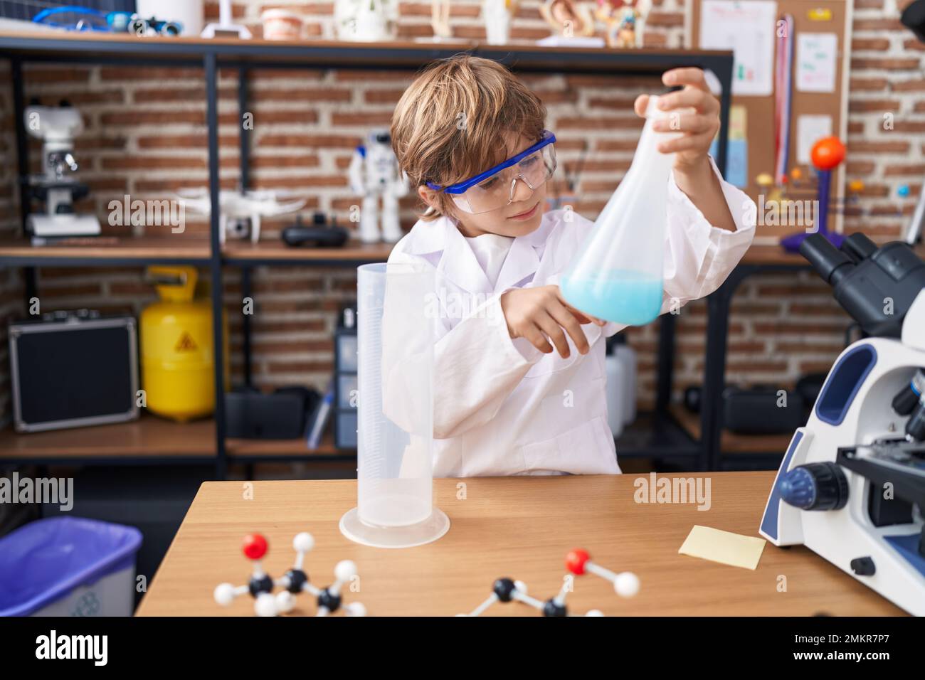 Adorable caucasian boy student holding test tube at classroom Stock ...