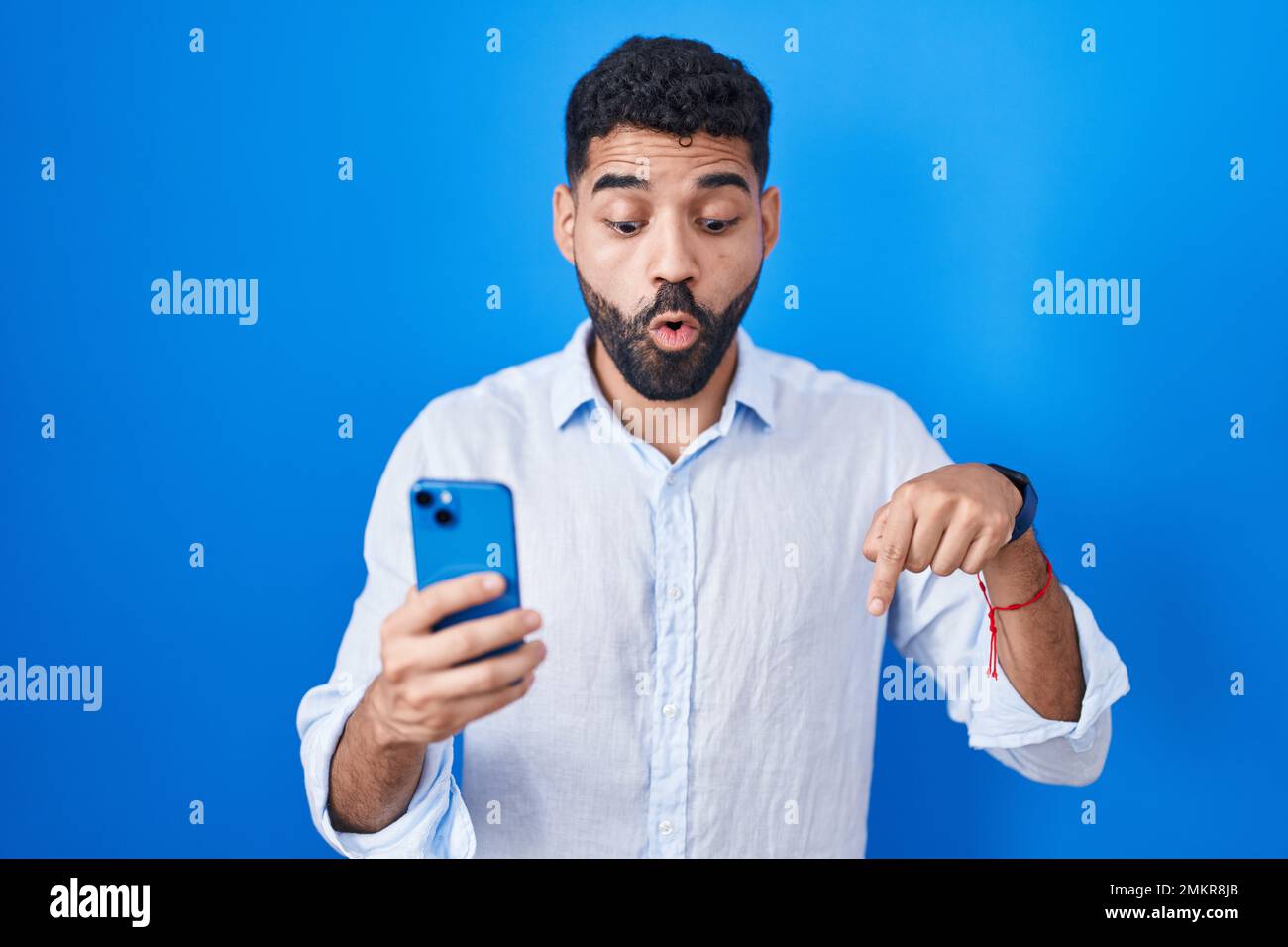 Hispanic Man With Beard Using Smartphone Typing Message Pointing Down