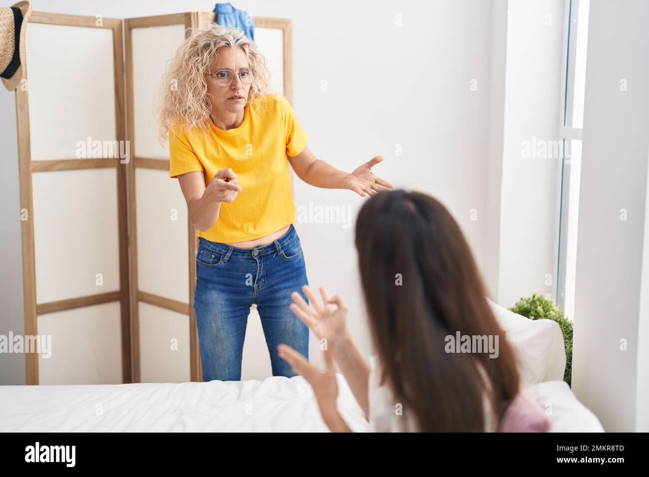 Two women mother and daughter arguing at bedroom Stock Photo - Alamy