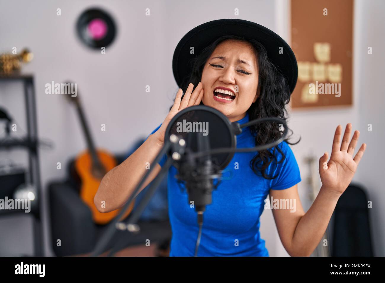 Young chinese woman artist singing song at music studio Stock Photo - Alamy