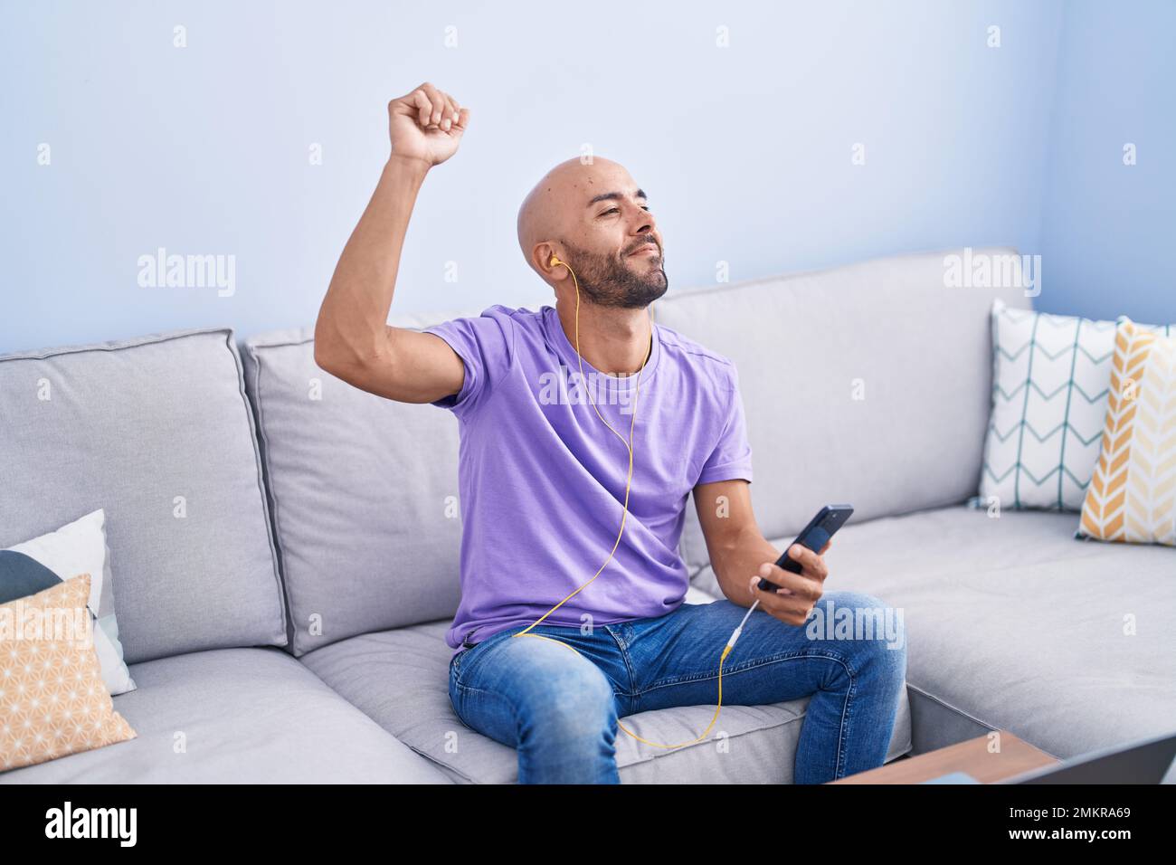 Young bald man listening to music and dancing at home Stock Photo - Alamy
