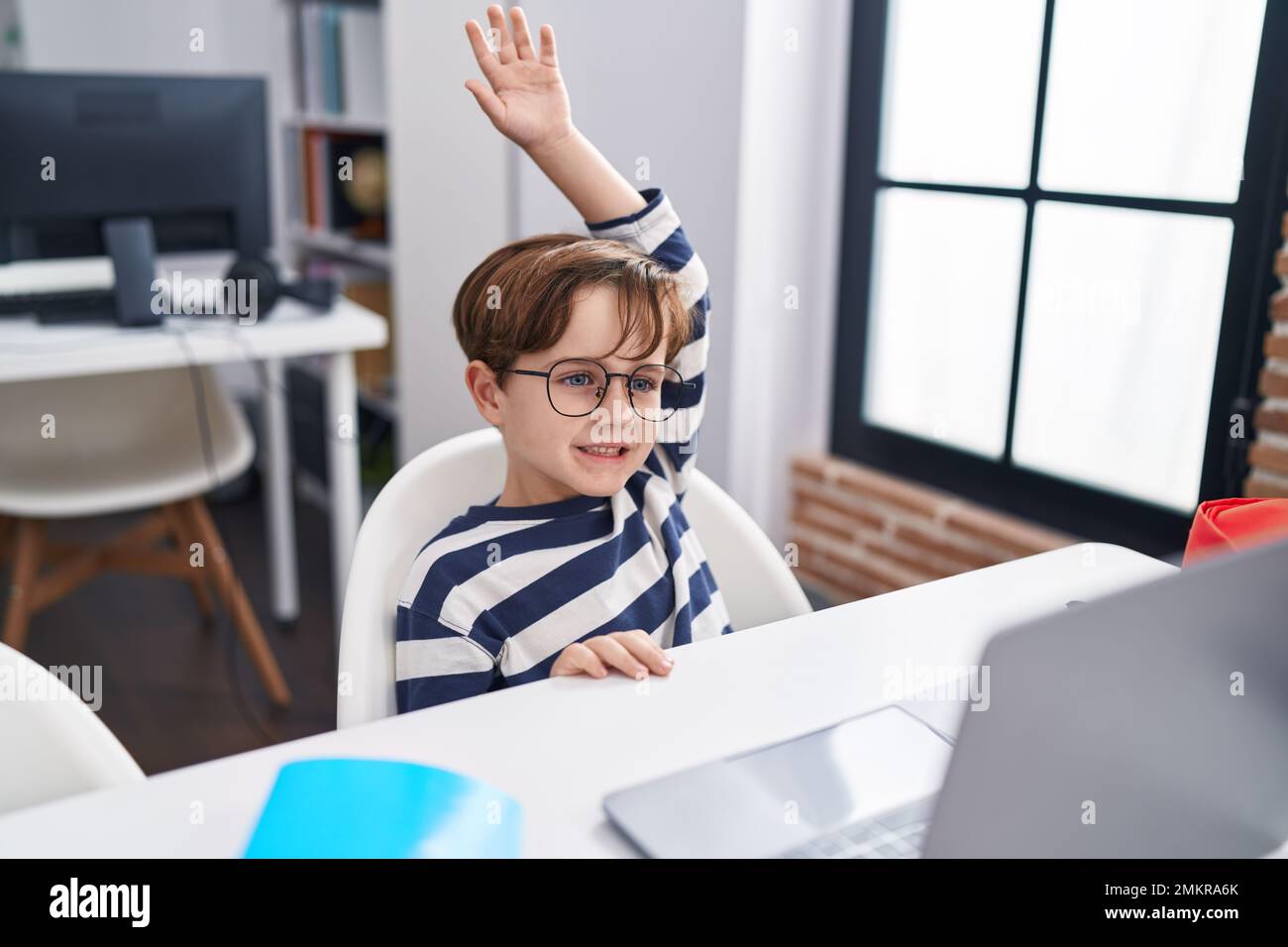Adorable hispanic boy student using computer having long distance ...