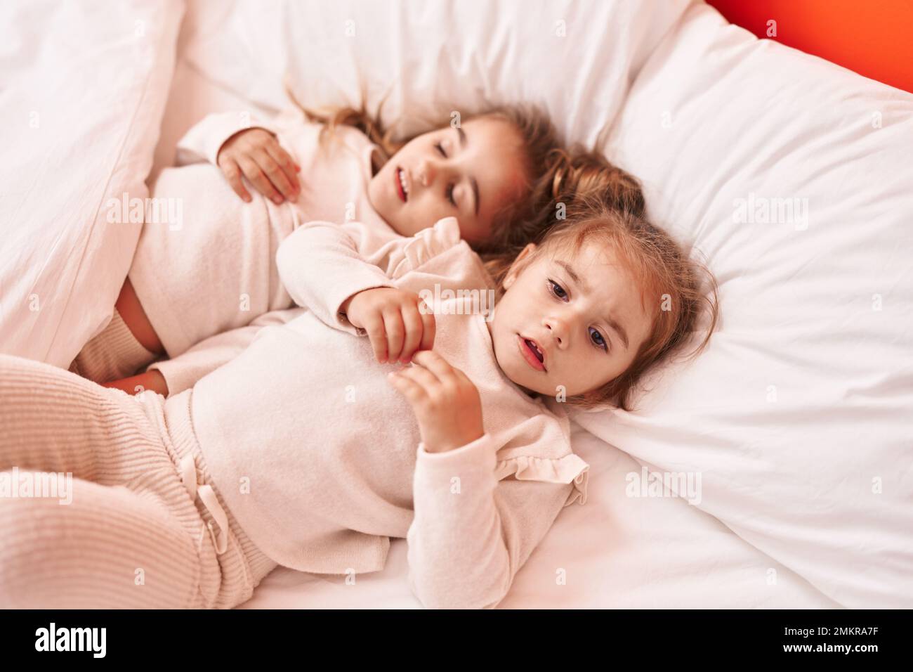 Two kids lying on bed at bedroom Stock Photo - Alamy