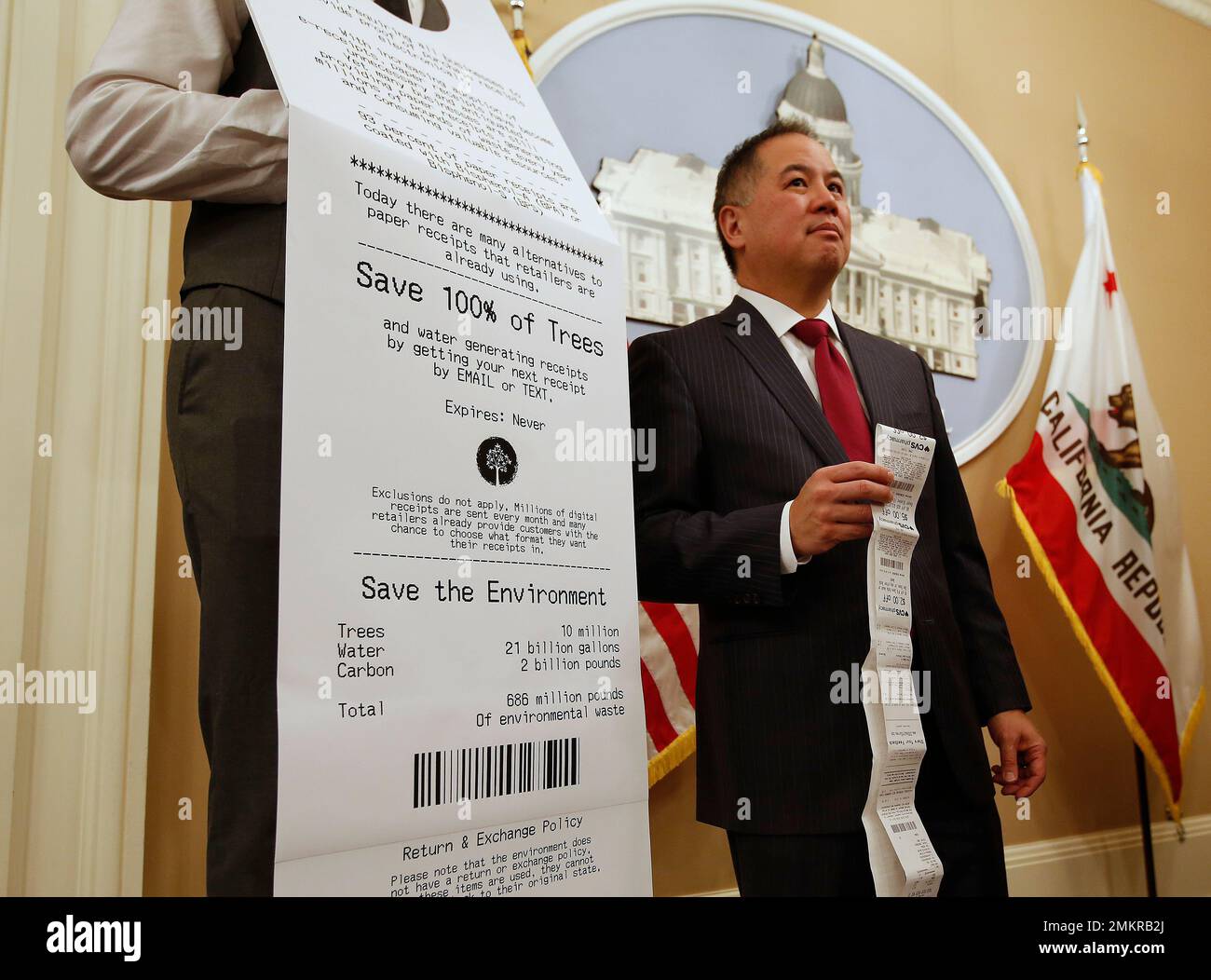 Assemblyman Phil Ting, D-San Francisco, displays a long paper receipt ...