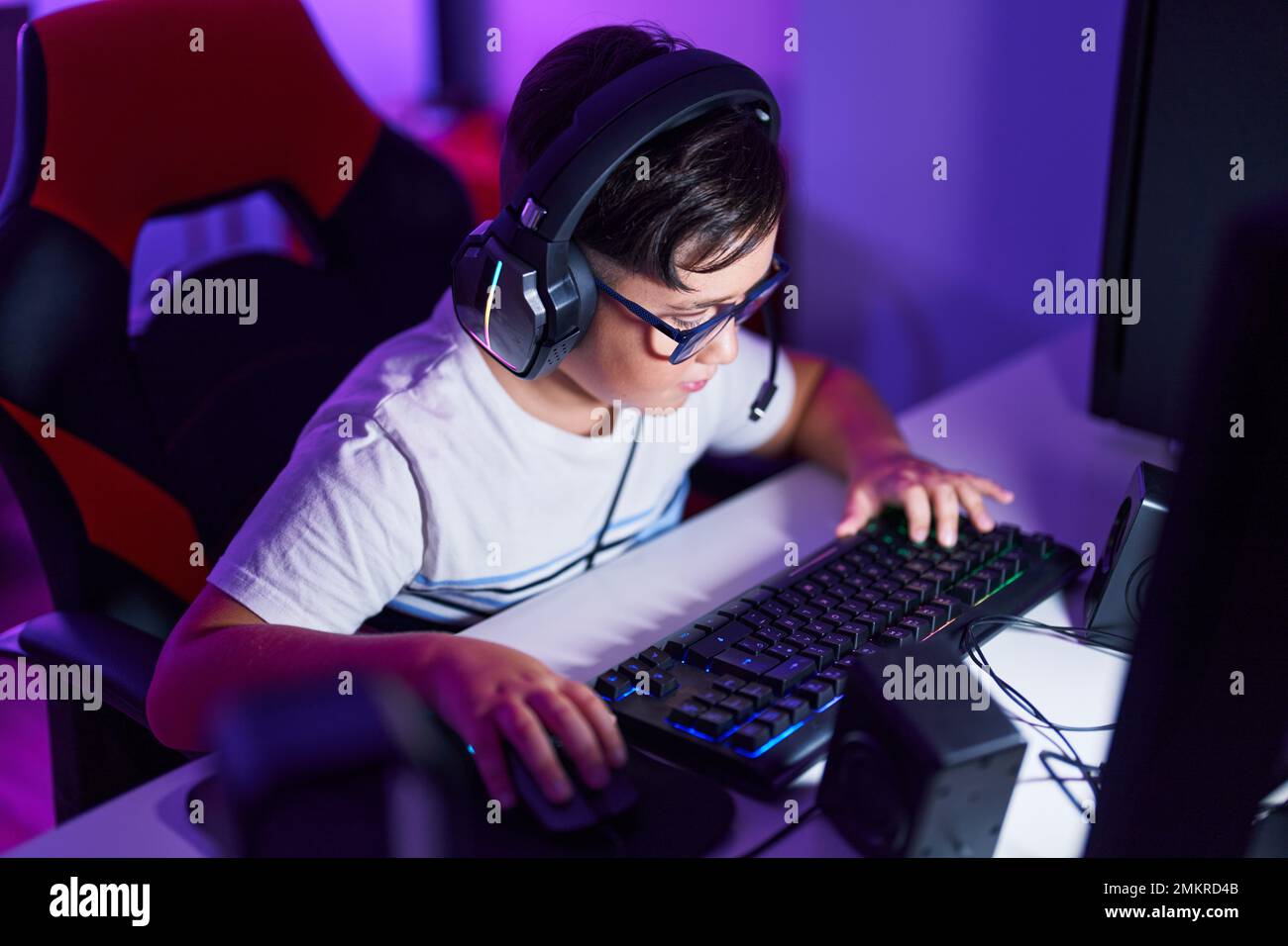 Adorable hispanic boy streamer playing video game using computer at ...
