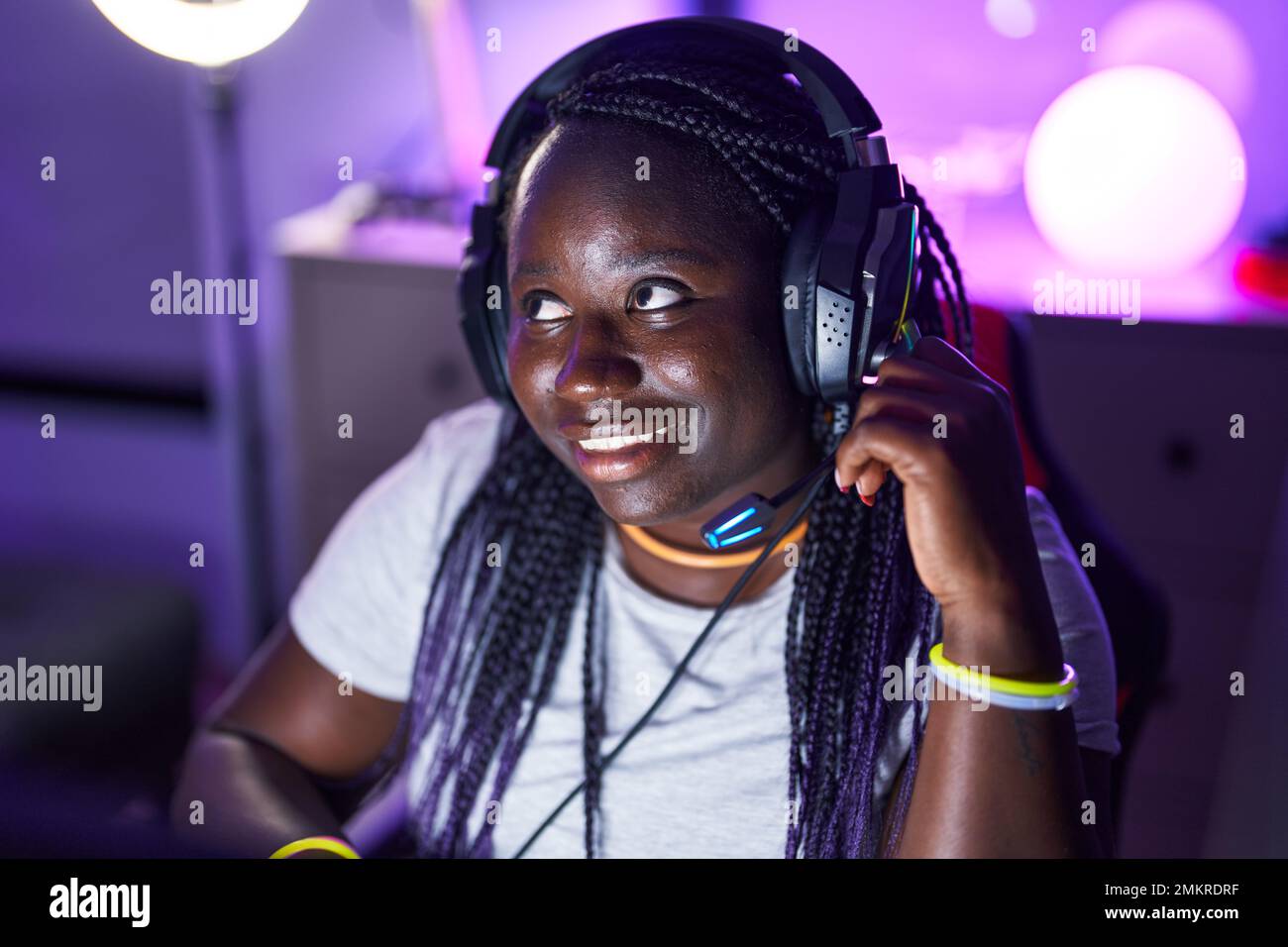 African american woman streamer smiling confident sitting on table at ...