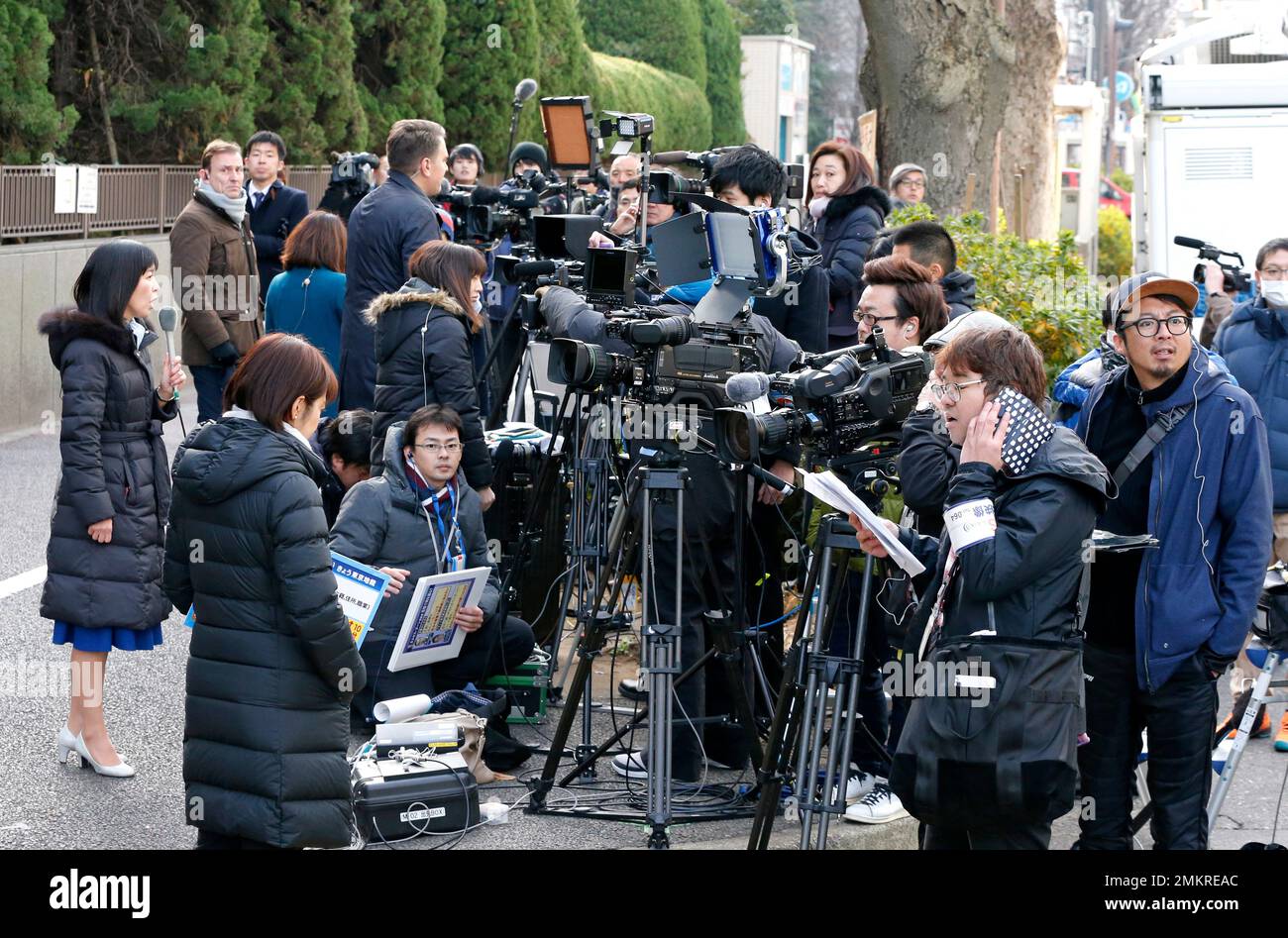 Reporters and cameramen stand by outside Tokyo District Court in Tokyo ...