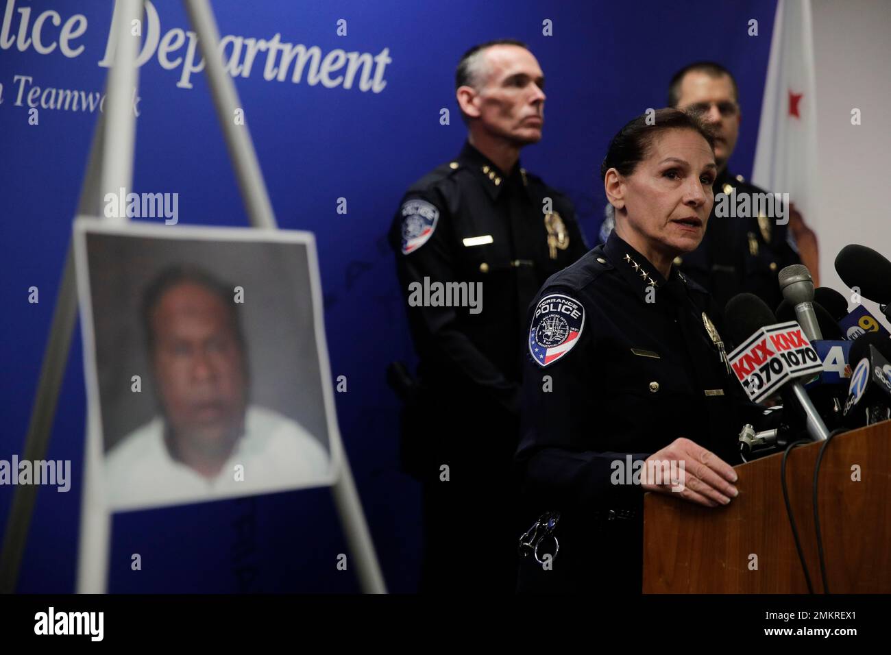 Torrance Police Chief Eve Irvine talks to reporters next to a photo of ...