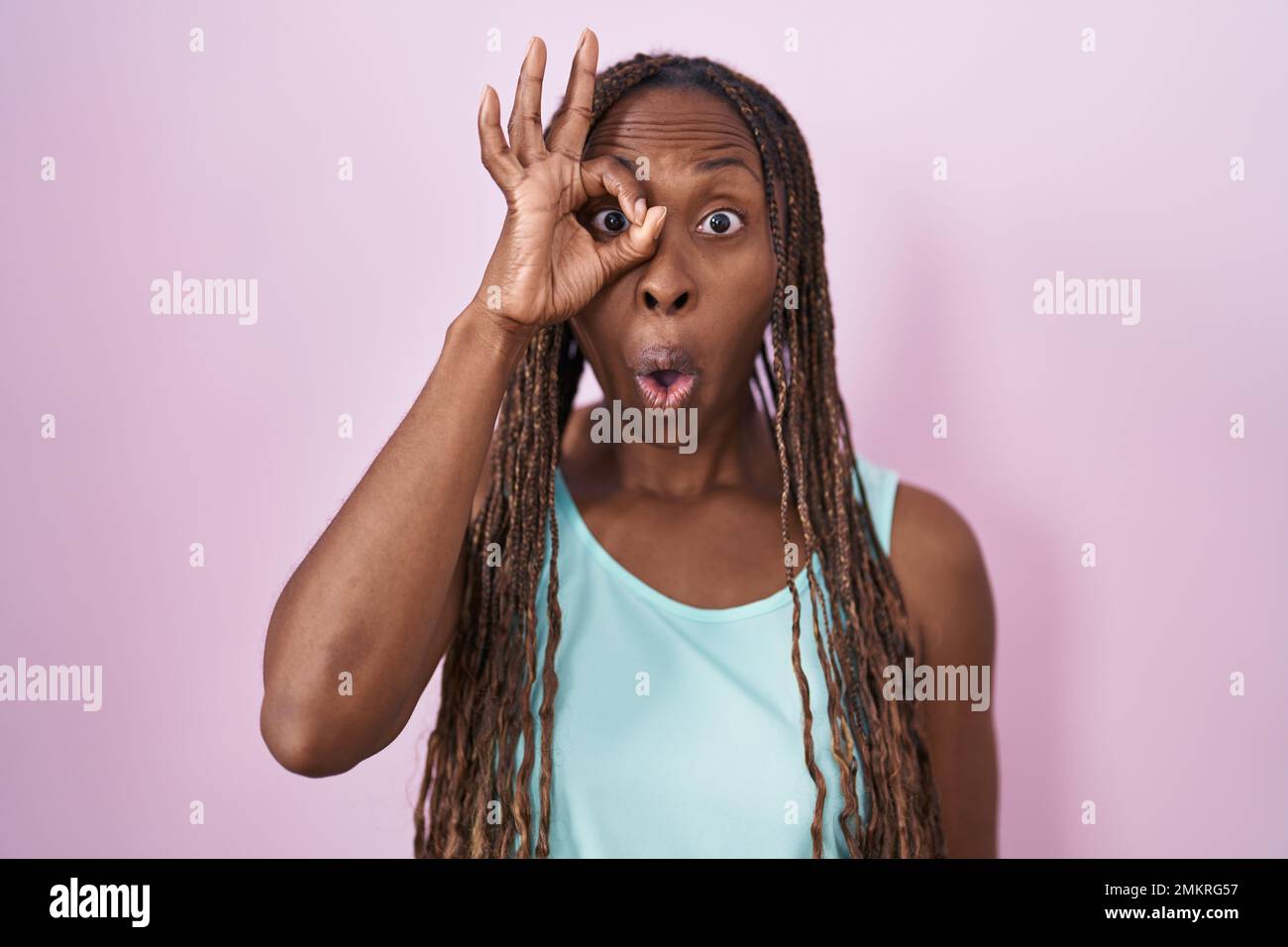 African american woman standing over pink background doing ok gesture ...