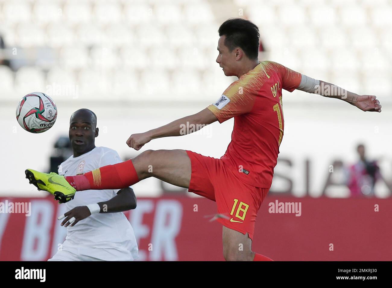 China's forward Gao Lin, right, clears the ball past Kyrgyz Republic's ...