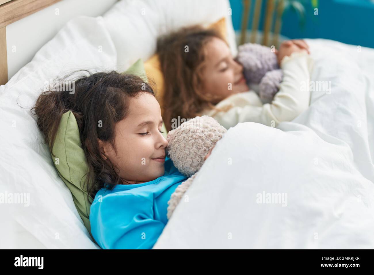 Two Children Sleeping In Bed