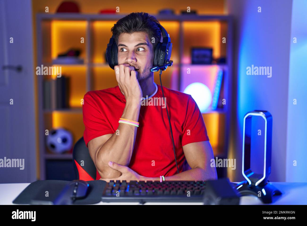 Young hispanic man playing video games looking stressed and nervous ...