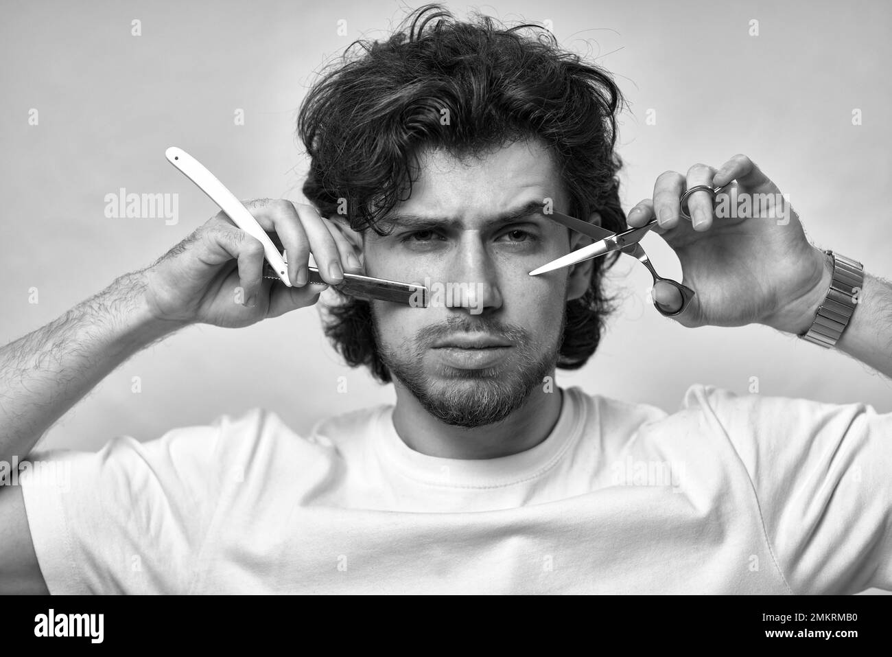 barber testing the sharpness of blade before cutting Stock Photo - Alamy