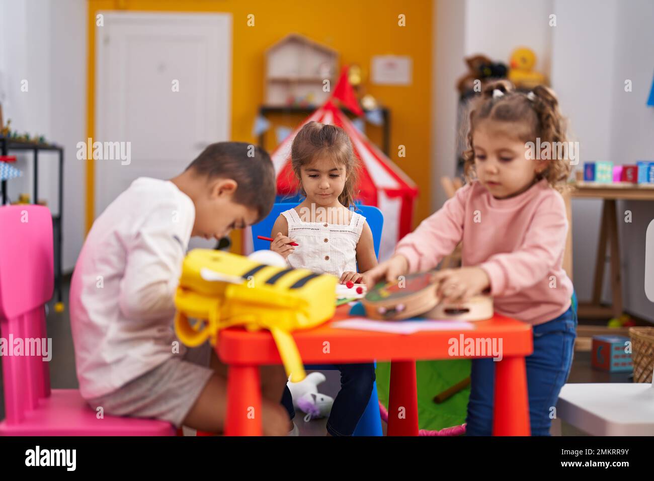 Group of kids preschool students sitting on table drawing on paper at ...