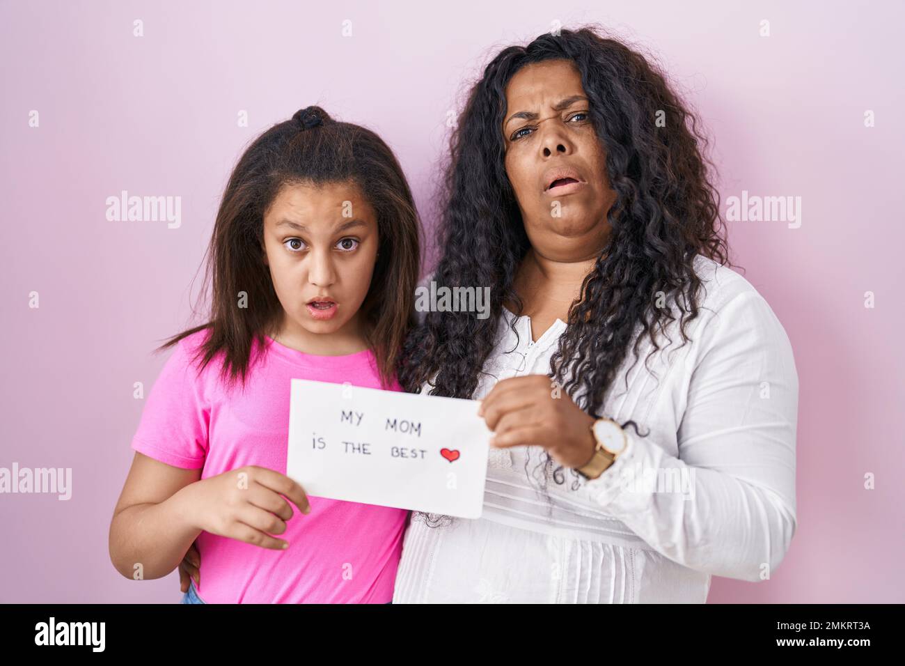 Mother and young daughter holding my mom is the best banner in shock ...