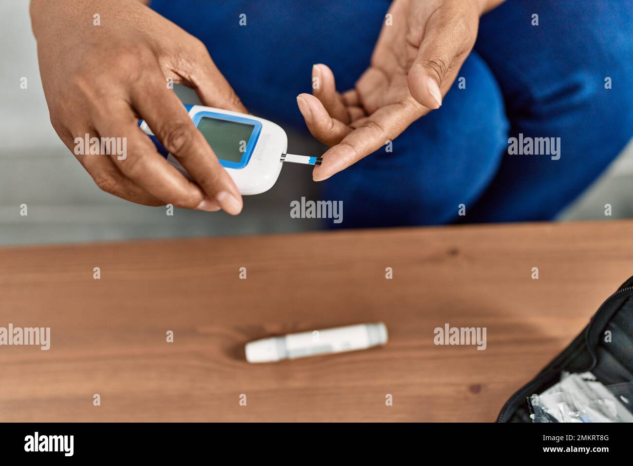 Senior african american woman measuring glucose at home Stock Photo - Alamy