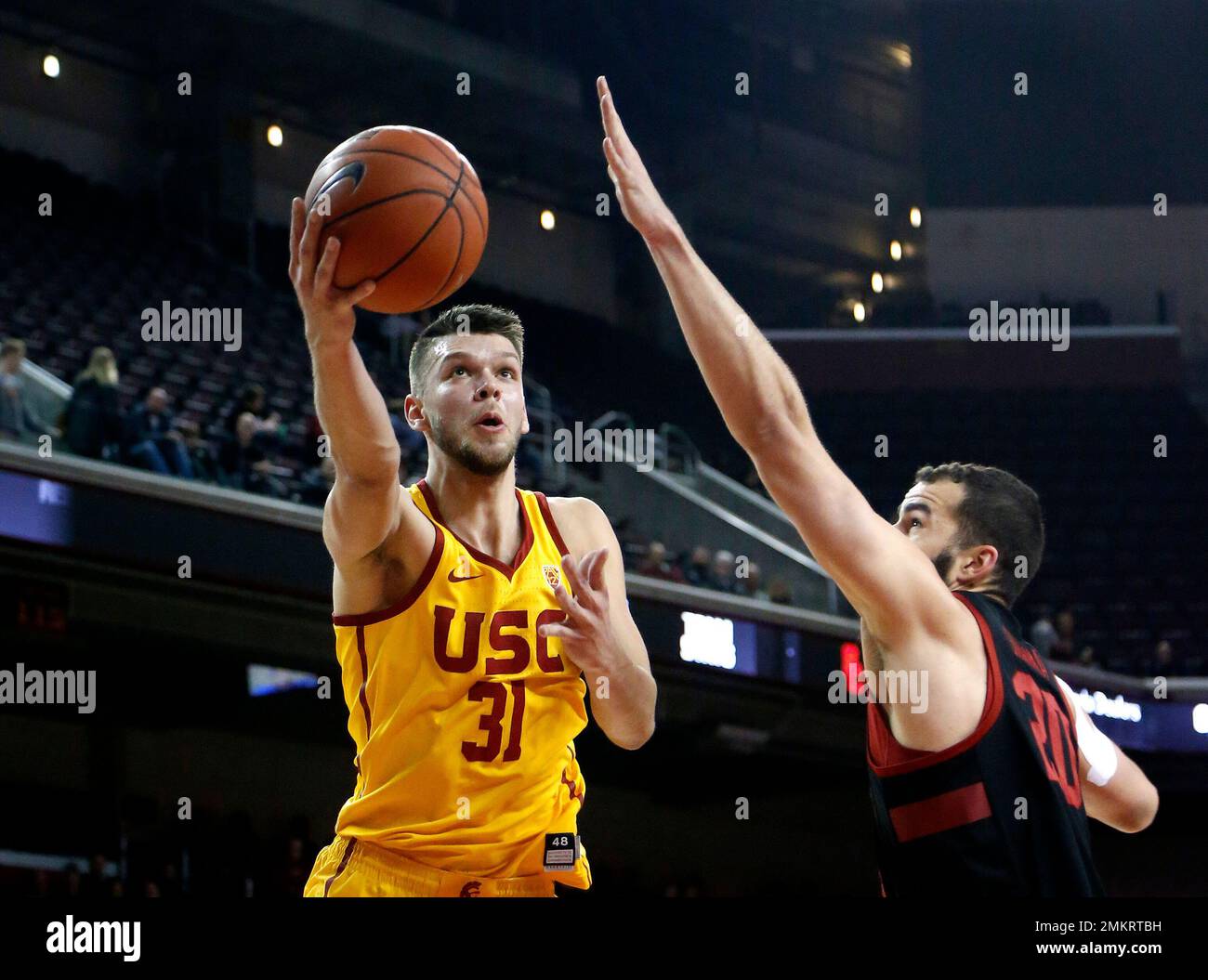 Southern California's Nick Rakocevic, left, goes to basket while ...