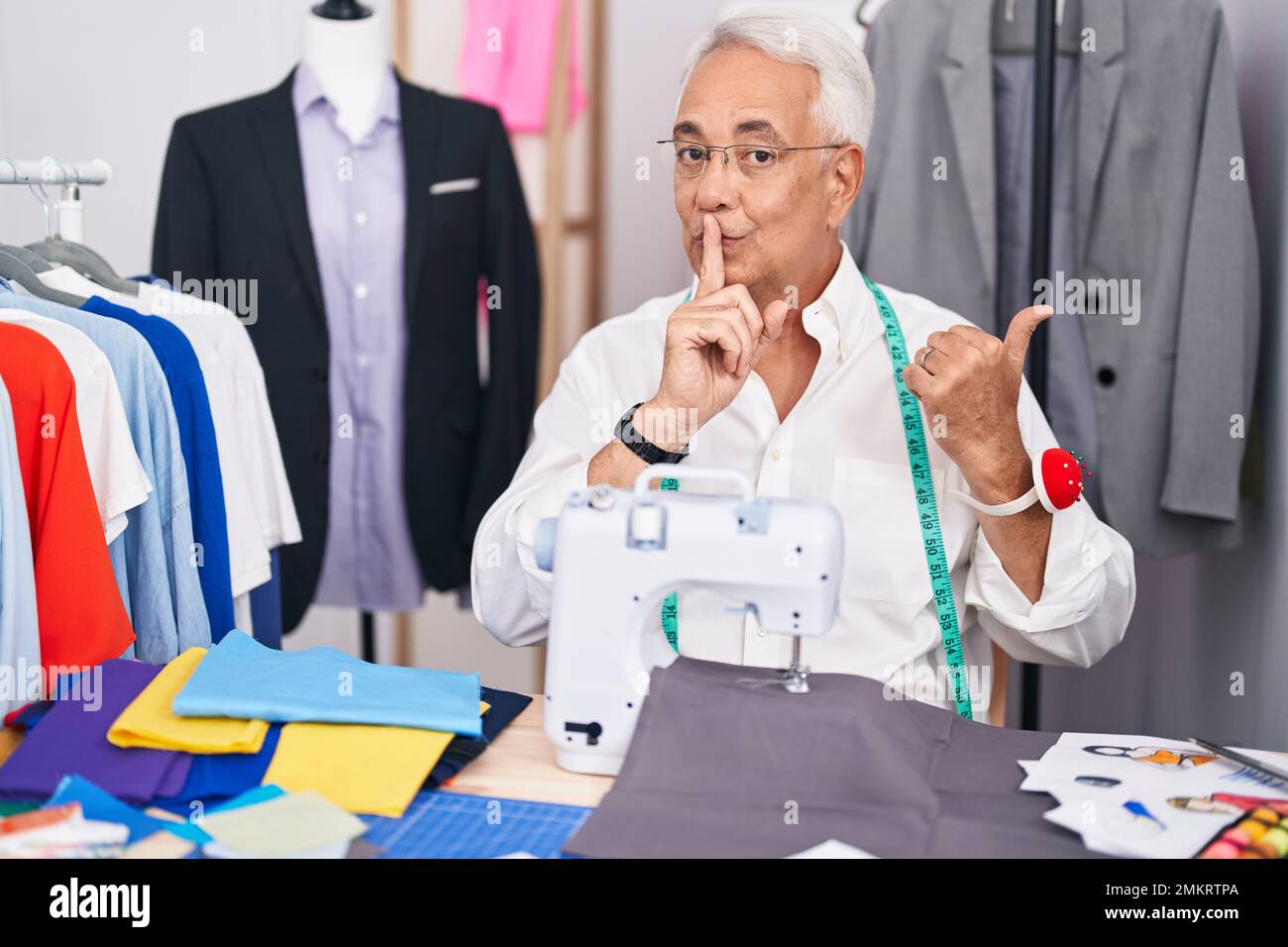 Middle age man with grey hair dressmaker using sewing machine asking to ...
