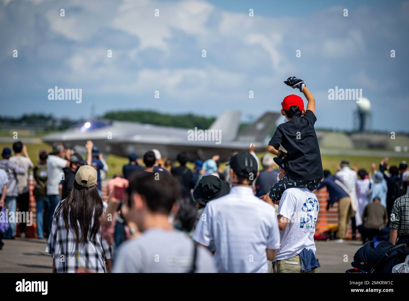 Attendees wave to a Japan Air Self-Defense Force (JASDF) F-35A ...