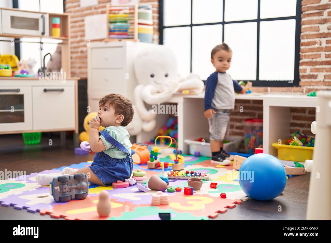 Two kids playing with toys at kindergarten Stock Photo - Alamy