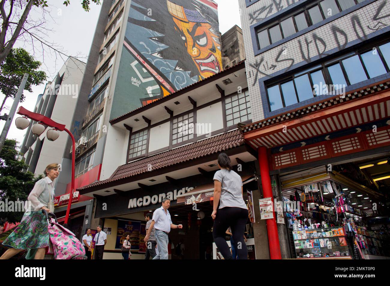 In this Dec. 27, 2018 photo, people walk under a mural of a Samurai in ...