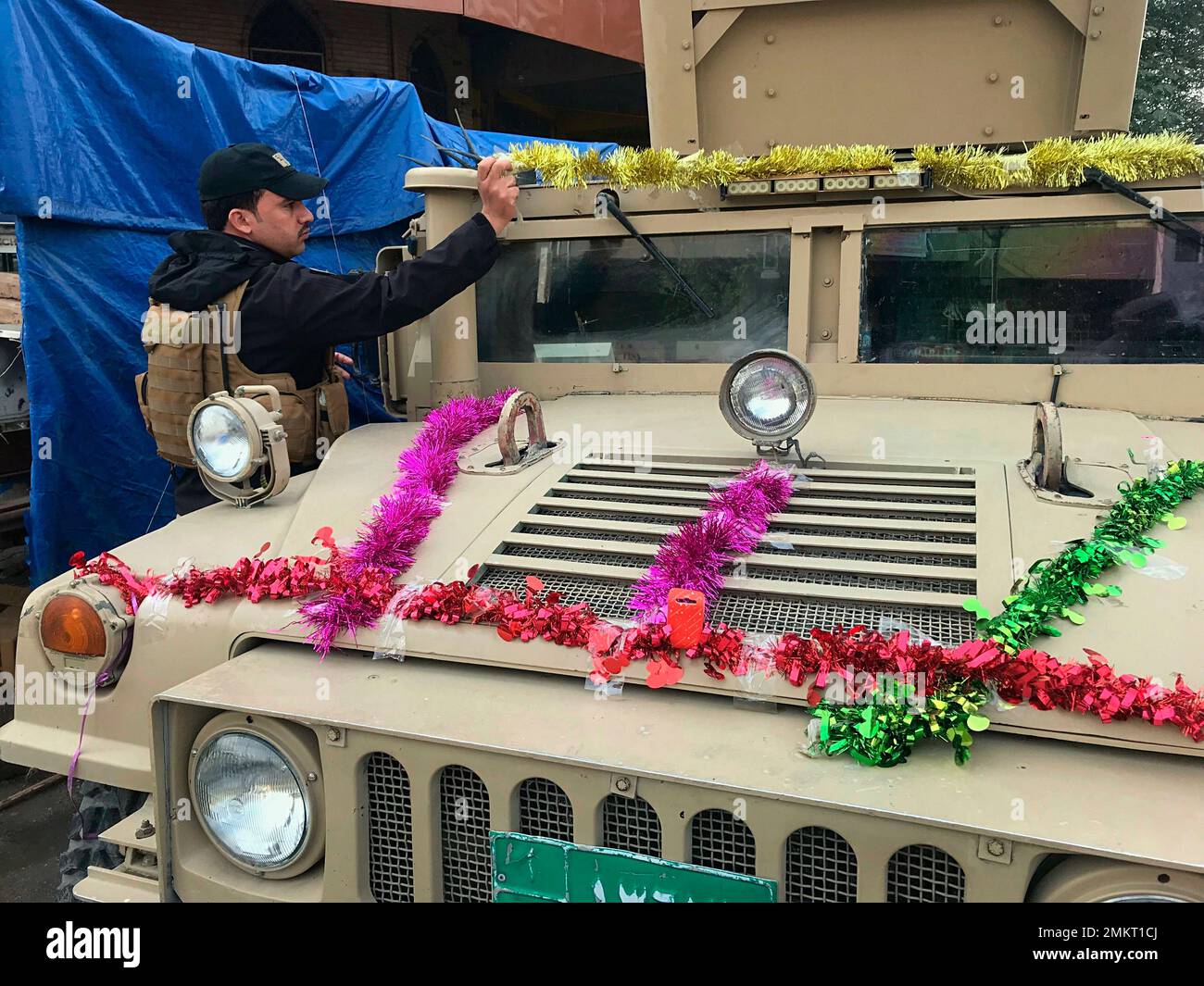 An Iraqi soldier decorates his armored vehicle, during Army Day ...