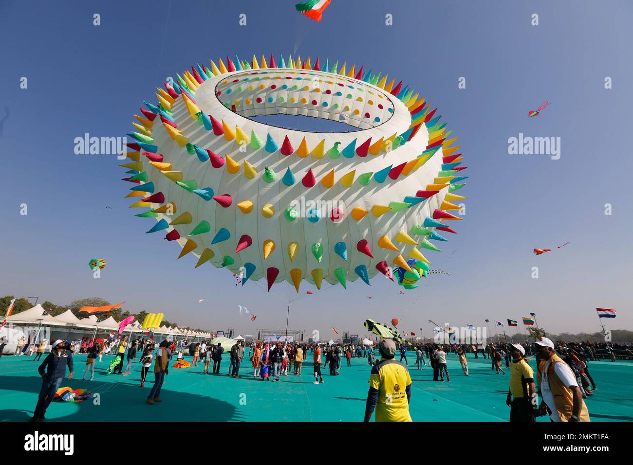 Indians watch a huge kite fly during International kite festival in ...