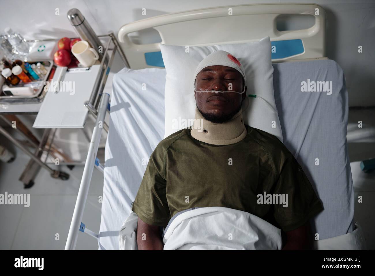 Soldier with bleeding head injury lying on hospital ward, view from ...