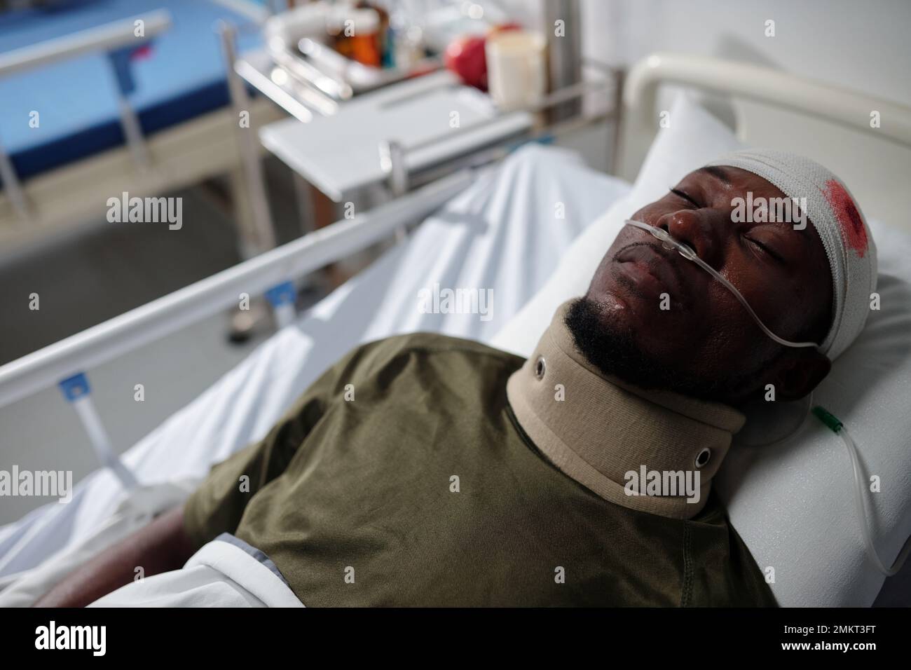 Soldier with splinter in head lying on bed in hospital ward Stock Photo ...