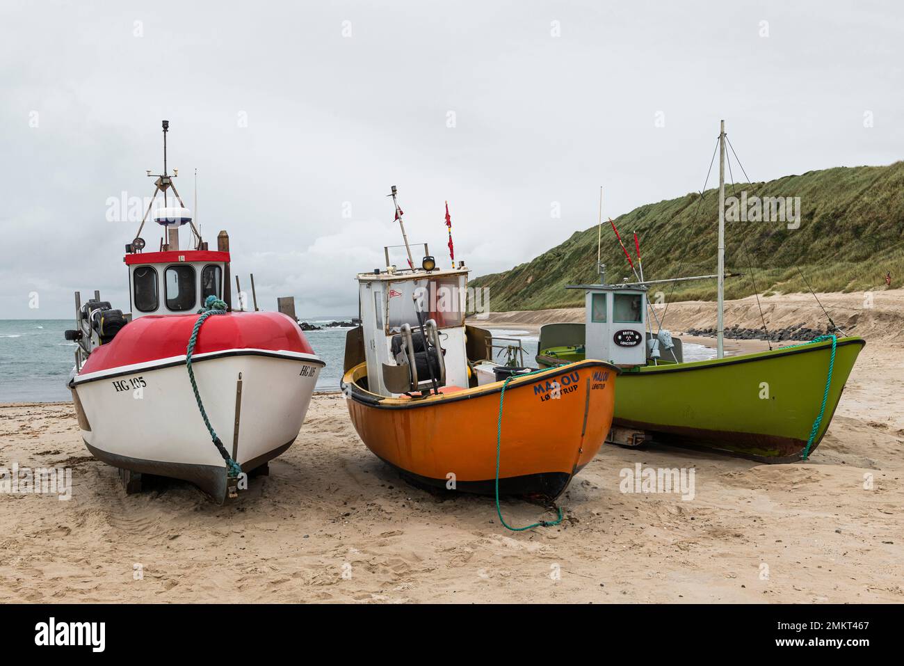 Denmark, North Jutland, Lönstrup: three colourful fishing boats towed ...