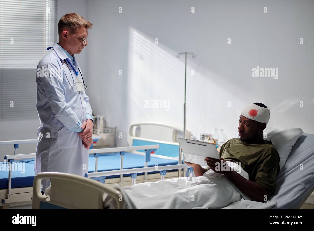 Doctor asking soldier to fill form before surgery Stock Photo - Alamy