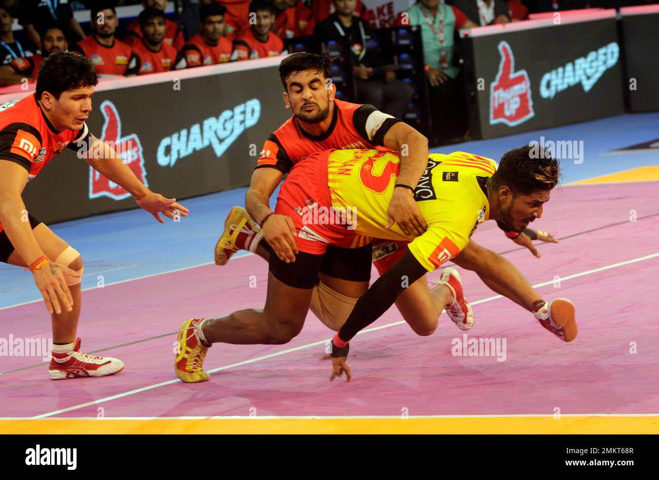 Players of Bengaluru Bulls attempt to pin down Gujarat Fortune giants K ...