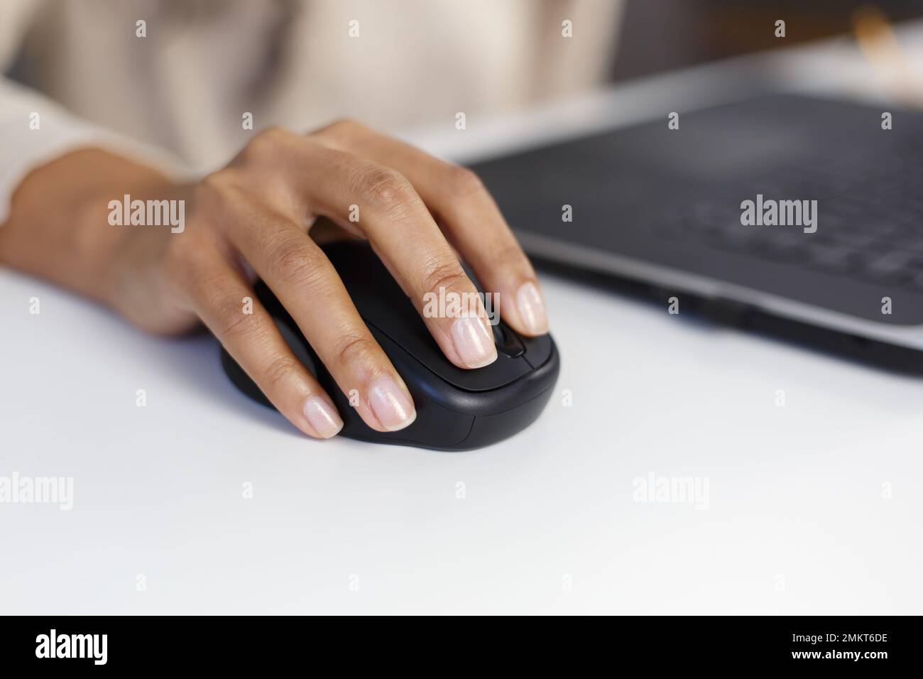 BIPOC woman works on computer in an office. Black female clicking with ...