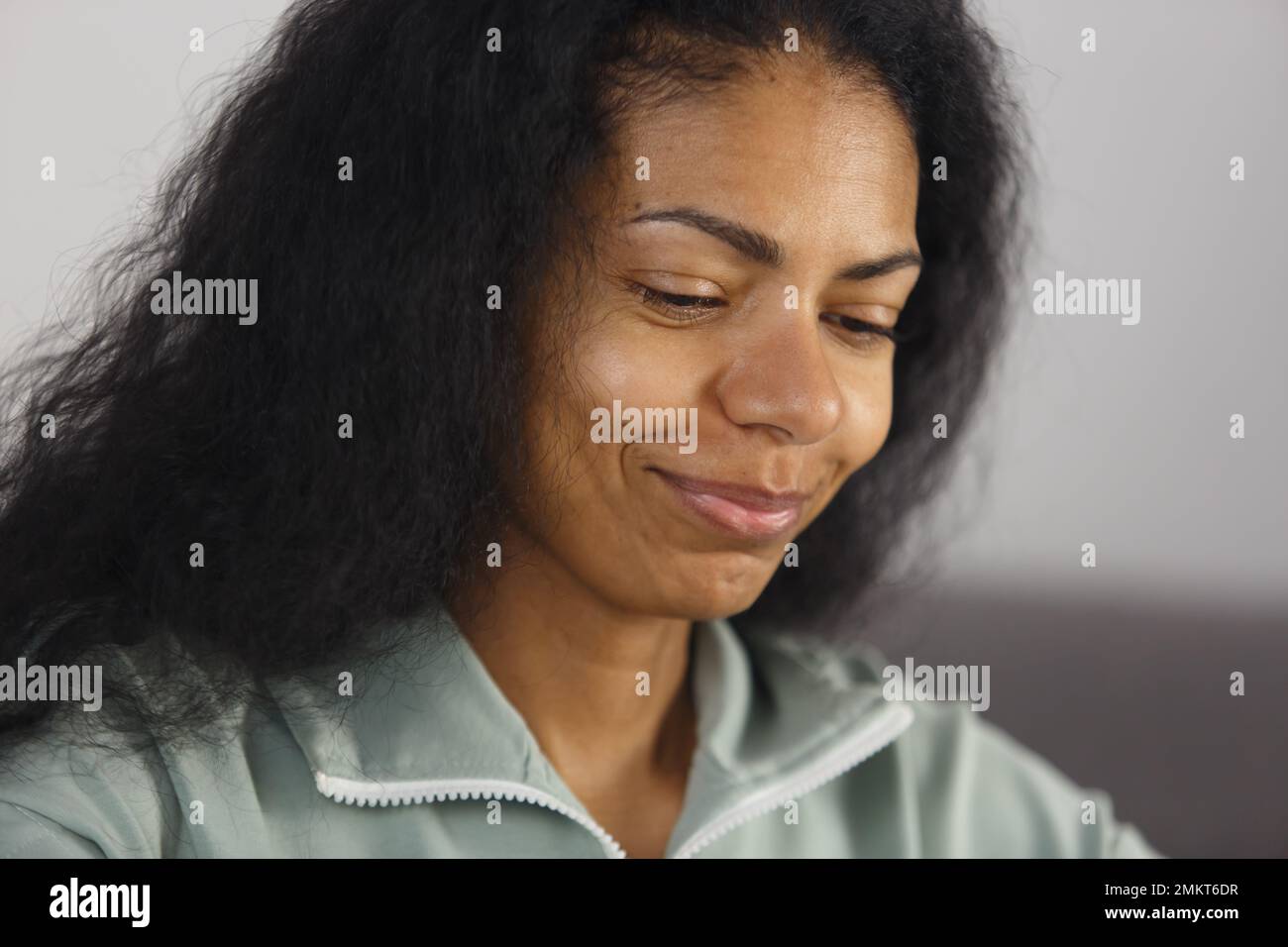 Pleased BIPOC woman works on computer at home. Close up portrait of ...