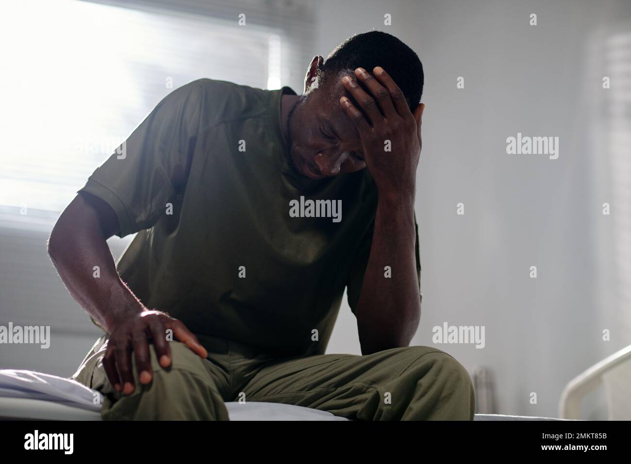 Stressed military man suffering from severe headaches after taking part ...