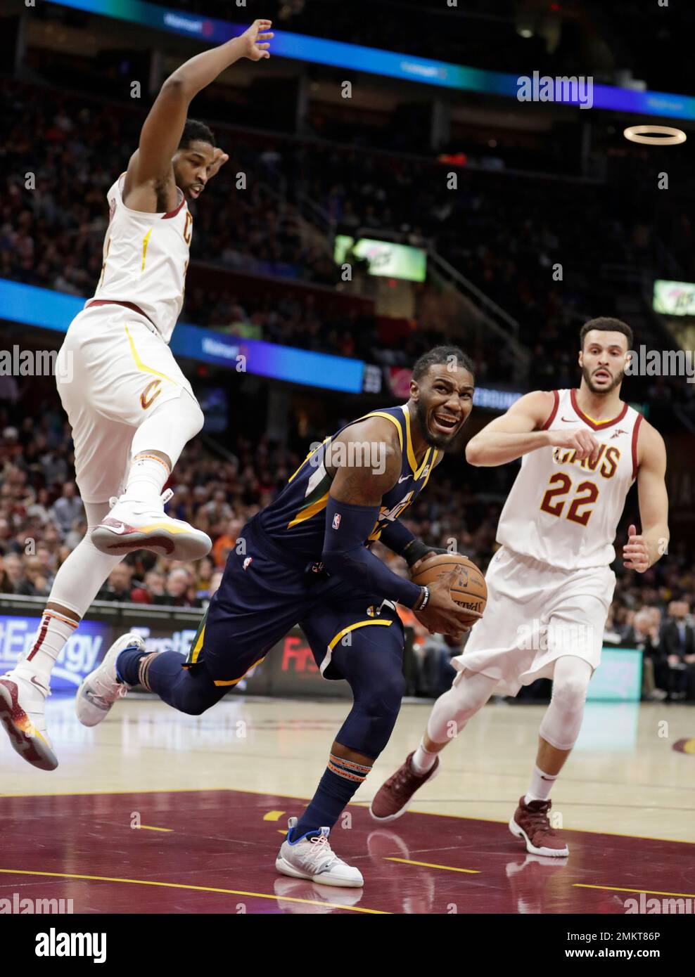 Utah Jazz's Jae Crowder, center, drives between Cleveland Cavaliers ...