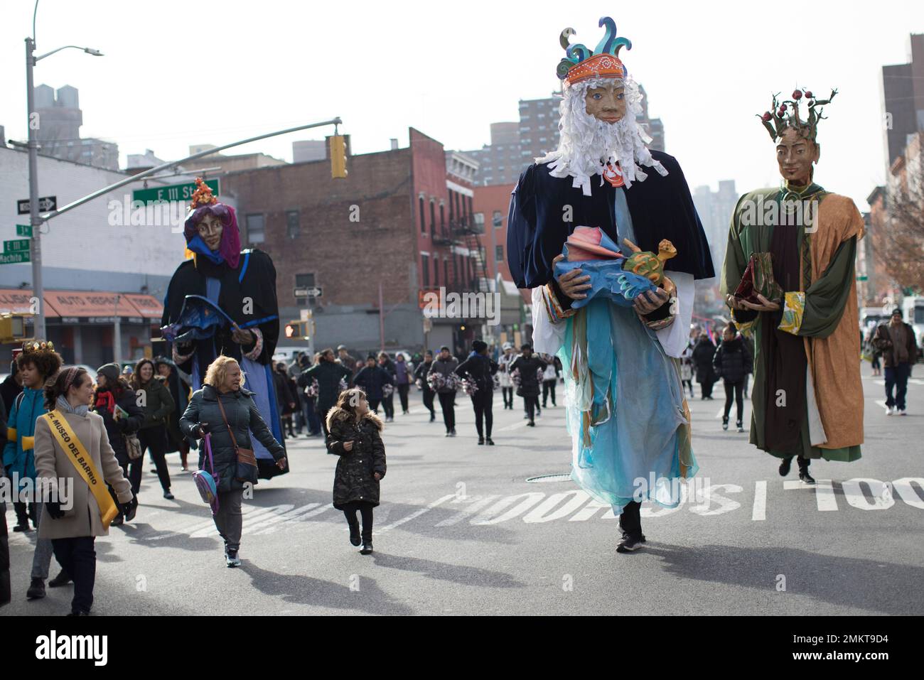 Puppeteers dressed as the three kings march up 3rd Avenue during El ...